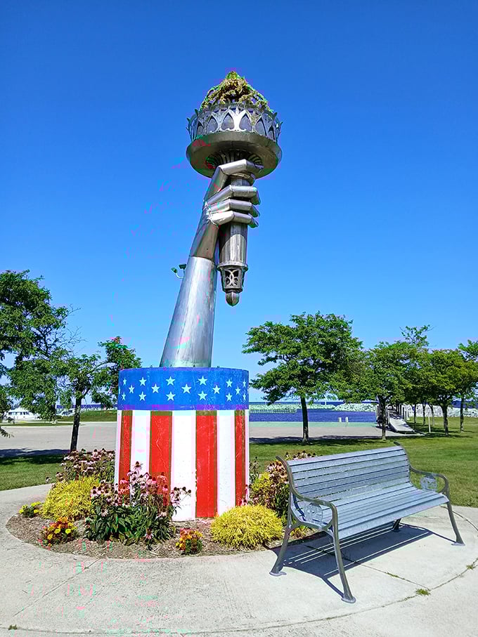 The Torch of Freedom sculpture stands proudly against blue skies, celebrating liberty in this quintessential American small town.