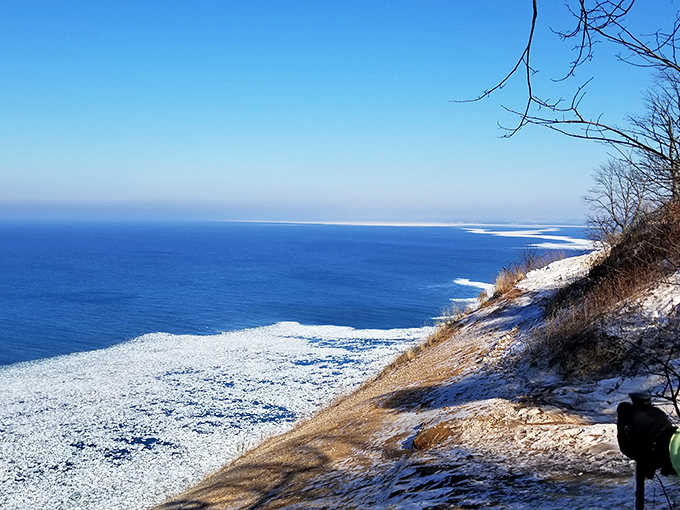 Winter's quiet magic transforms familiar landscapes into mysterious new territories, with Lake Michigan partially frozen in the distance.