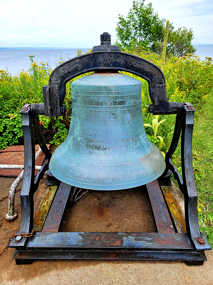 This weathered bell once cut through fog and darkness, its metallic voice carrying hope to lost sailors on stormy nights.
