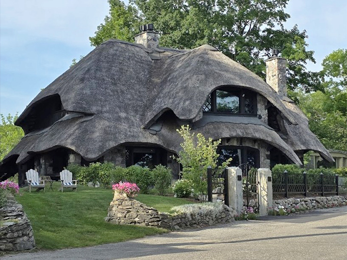 The undulating roofline mimics waves from nearby Lake Michigan, creating a visual rhythm that dances across the Charlevoix skyline.