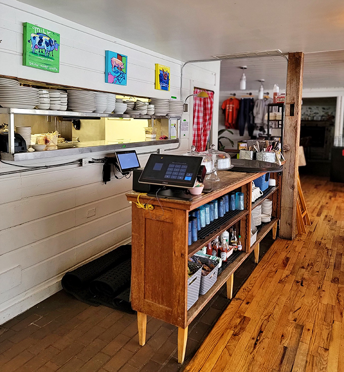 The counter area reveals the restaurant's attention to detail, with colorful artwork adding pops of personality to the clean, functional space.
