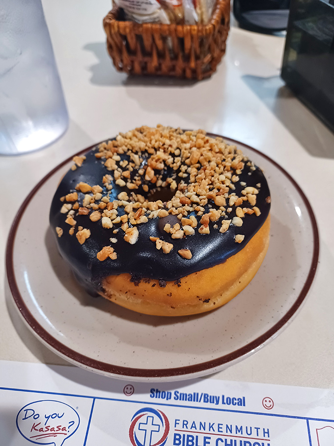 Chocolate-glazed perfection topped with crushed peanuts – proof that sometimes the simplest desserts deliver the most satisfaction.