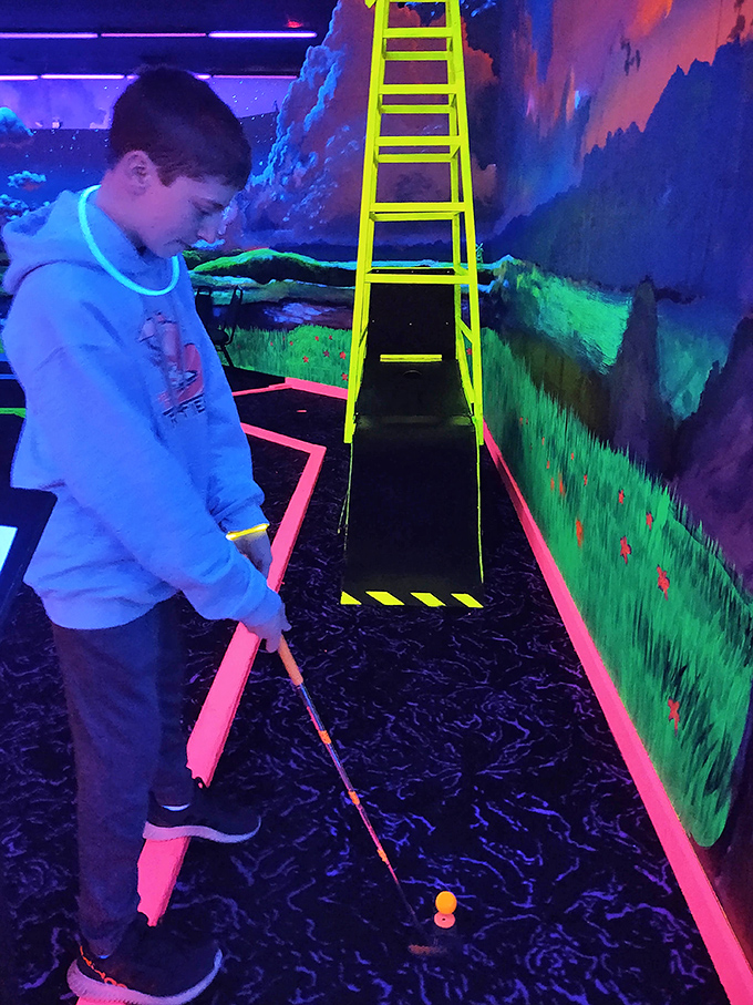 Young putters face the challenge of neon slopes and glowing hazards, where even missed shots look spectacular.