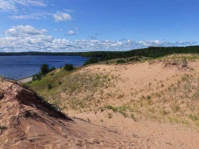 Wind-sculpted dunes create nature's perfect amphitheater, with Lake Superior providing the soundtrack just beyond the ridge.