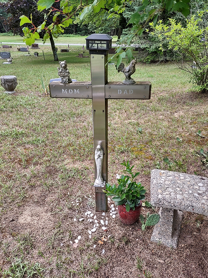 A touching memorial cross marked simply "Mom" and "Dad" features charming figurines, showing how personal touches make grief more bearable.