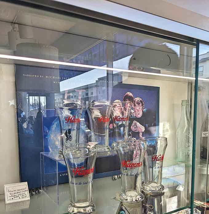 Vintage Hamm's glassware gleams behind glass, each tumbler a vessel for both beverages and nostalgia.