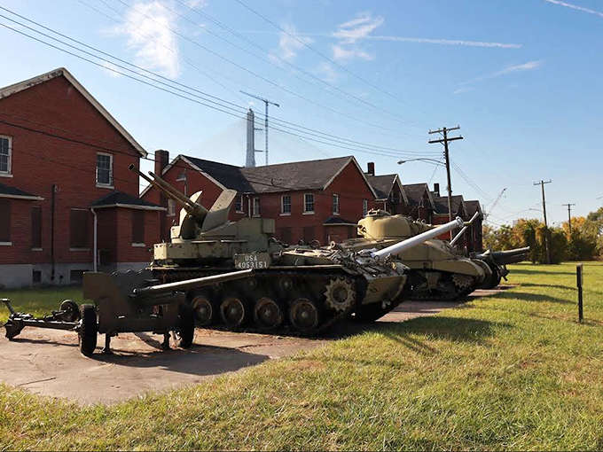 These military tanks sitting on the parade ground create a striking contrast between 19th-century brick architecture and 20th-century armored warfare technology.
