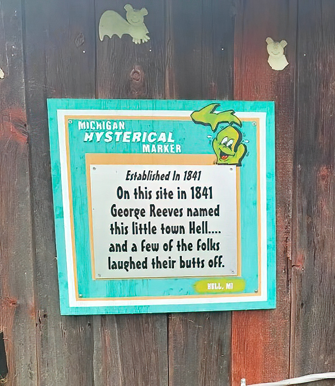 The Michigan Hysterical Marker delivers the town's origin story with characteristic humor, explaining Hell's naming with perfect comedic timing.