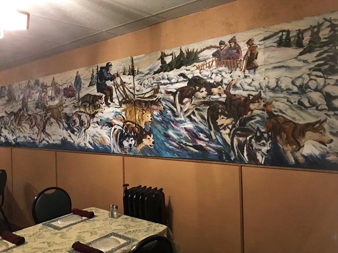 The dining room tells stories through its décor – a striking mural capturing Wisconsin's outdoor heritage adorns the wall.