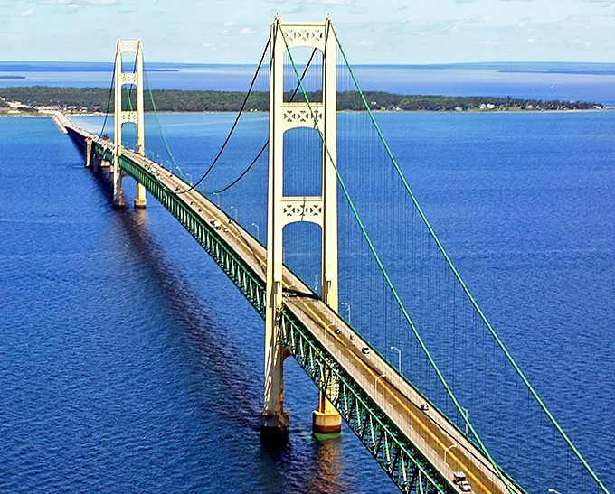 From above, the Mackinac Bridge's elegant suspension design reveals itself, a thin line connecting Michigan's wilderness to its industrial heart.