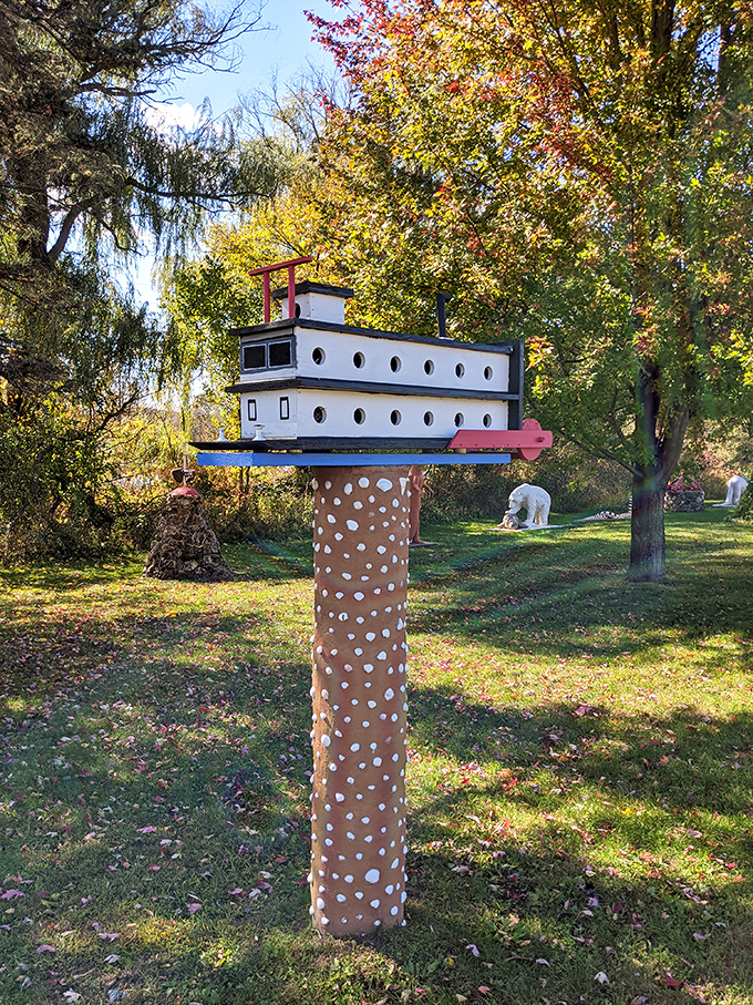 A whimsical mailbox perched atop a spotted pillar proves that even the most mundane objects deserve artistic treatment at Prairie Moon.