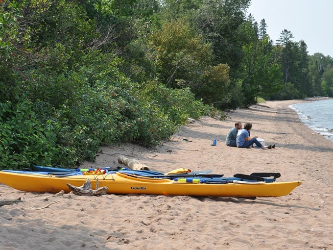 Peaceful shorelines offer the perfect spot for kayakers to launch their adventures, with water so clear you can count pebbles below.