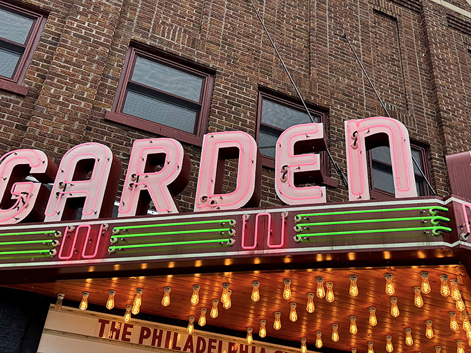 Neon letters announce "GARDEN" to the world, a glowing invitation to step back in time for a few magical hours.