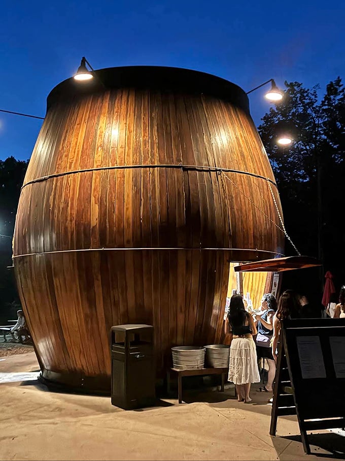 As dusk falls, the Root Beer Barrel glows like a lantern in the night, drawing in hungry travelers like moths to a delicious flame.