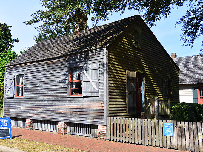 Dappled shade from ancient oaks embraces the cottage, a partnership of nature and architecture that's survived countless storms.