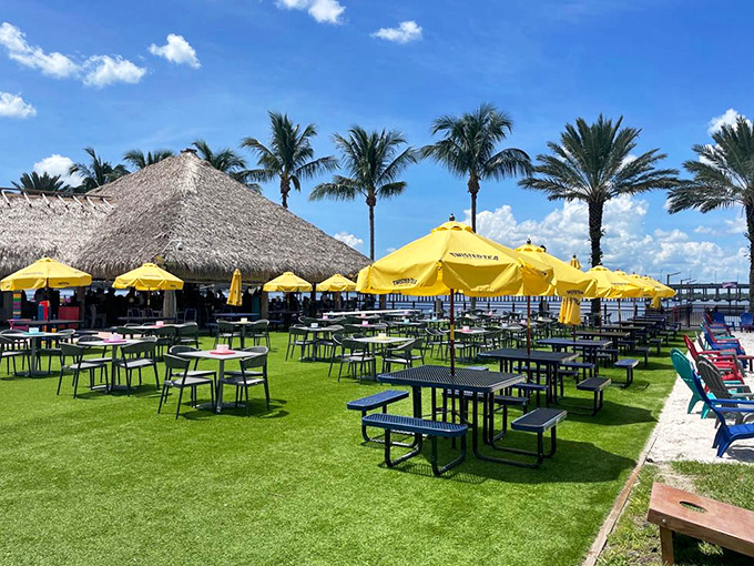 Yellow umbrellas dot the landscape like tropical butterflies, creating pockets of shade perfect for lingering over lunch or afternoon drinks.