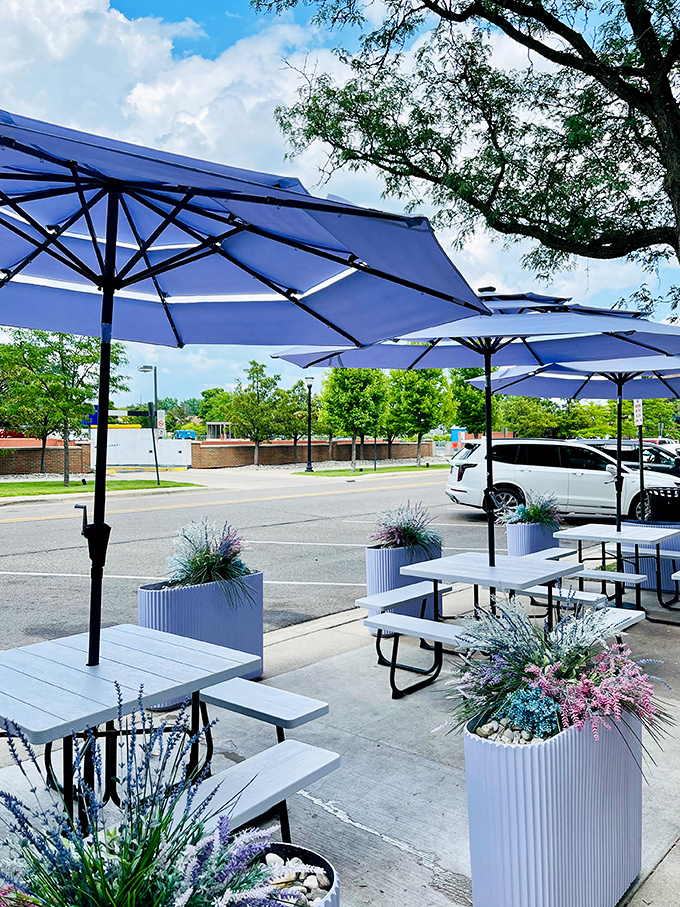 The outdoor seating area offers a perfect summer escape &ndash; lavender plantings and blue umbrellas creating an oasis for enjoying frozen treats.