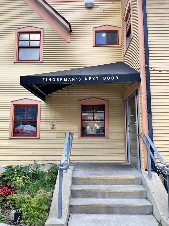 Zingerman's Next Door offers a sunny yellow welcome, with steps leading to a porch where coffee and conversation flow as freely as the Michigan breeze.