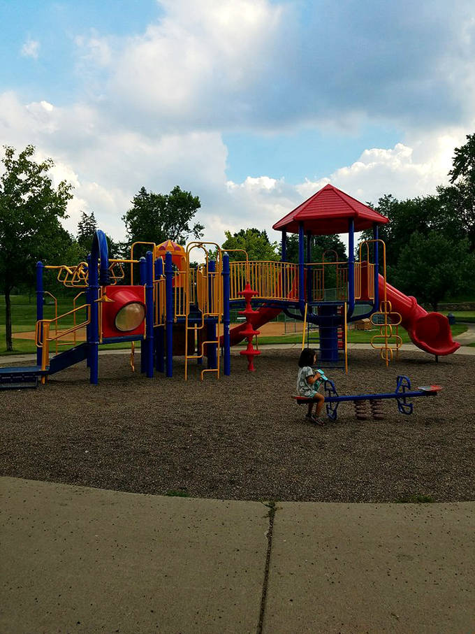 Modern playground equipment offers young beachgoers a break from swimming, though convincing kids to leave the water requires parental negotiation skills.
