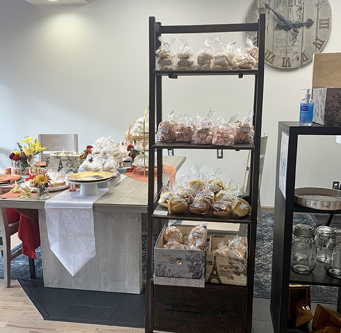 Freshly baked goods await on rustic shelves, each package promising to extend the French Lady experience beyond the restaurant walls.