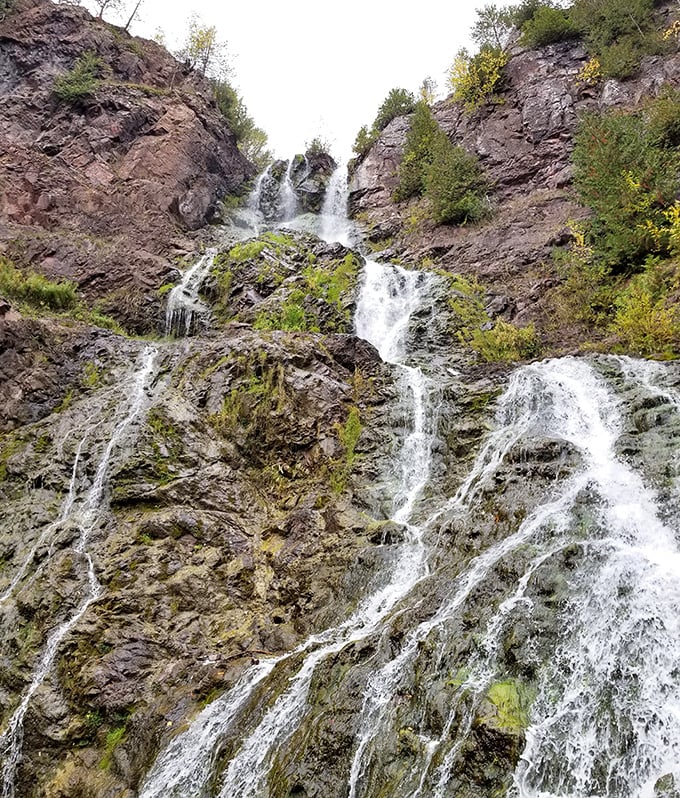 Up close, the waterfall reveals its true power and complexity. Each rivulet finds its own path down the rock face, like nature's improvisational dance.