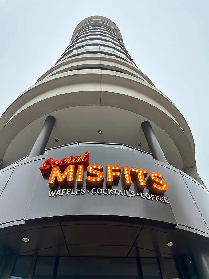 Looking up reveals the dramatic cylindrical building that houses Social Misfits, its distinctive shape becoming a beacon for food lovers.