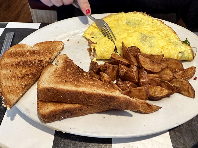 A perfect omelet with home fries that achieve the mythical balance of crispy exterior and tender interior &ndash; breakfast nirvana on a plate.