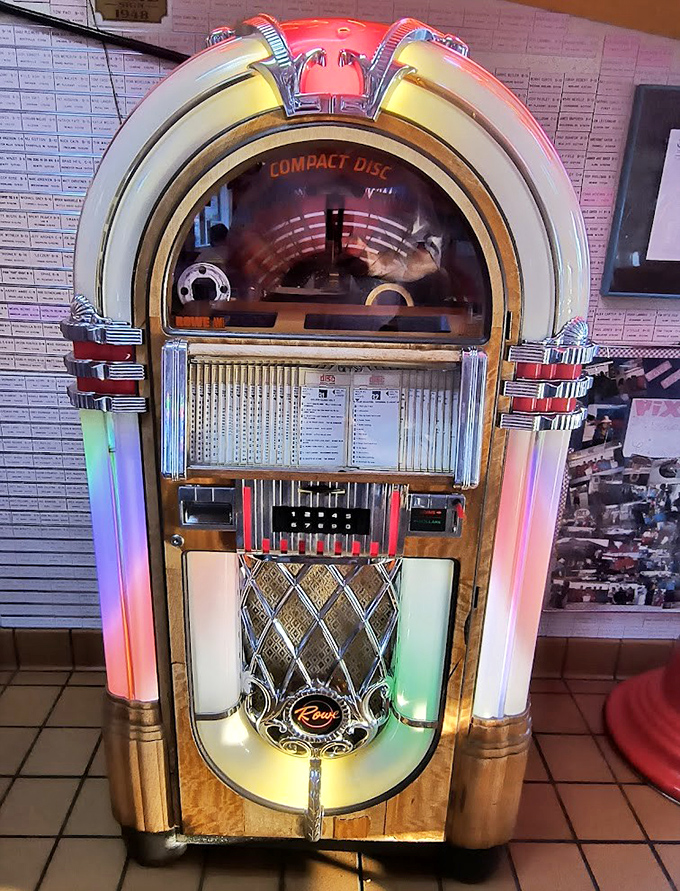 The vintage jukebox stands as a glowing guardian of good times, promising classic tunes from rock's golden era.