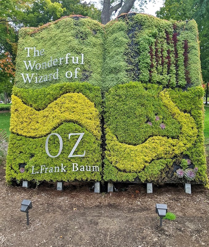The magnificent topiary book serves as the garden's centerpiece, thousands of plants meticulously shaped to form Baum's literary masterpiece.