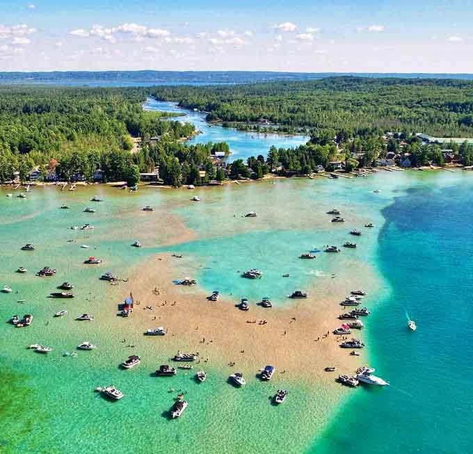 The aerial view reveals Torch Lake's true splendor &ndash; a 19-mile sapphire nestled in Michigan's northern forests, drawing boaters to its famous sandbar.