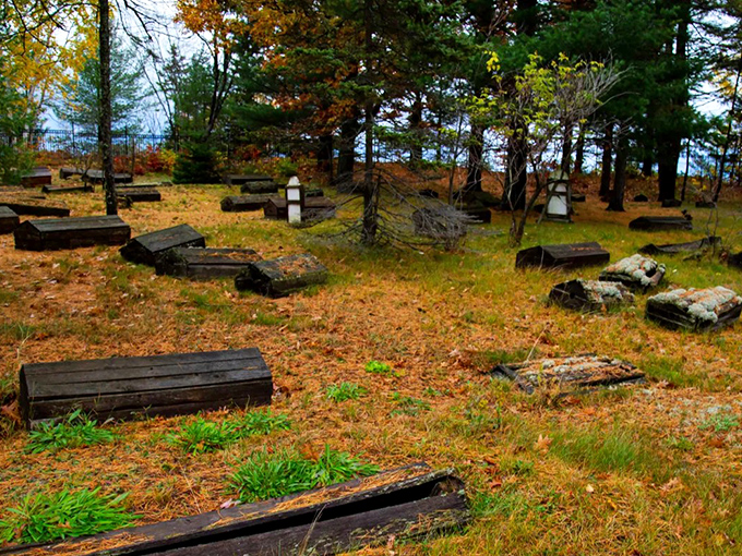Fall brings a carpet of golden leaves, nature's way of honoring those who rest beneath these humble wooden shelters.