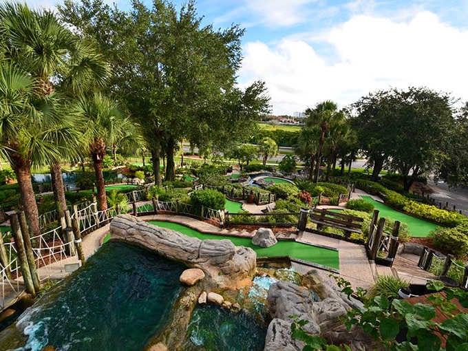 The aerial view reveals the course's intricate design, a verdant maze of putting challenges nestled among water features and lush landscaping.