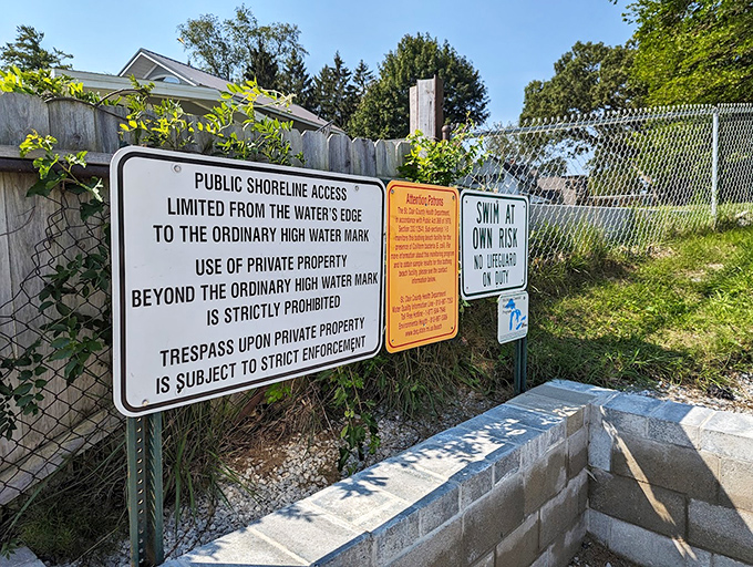 Public access meets private property along Michigan's shoreline, where signs remind visitors of the delicate balance between enjoyment and respect.