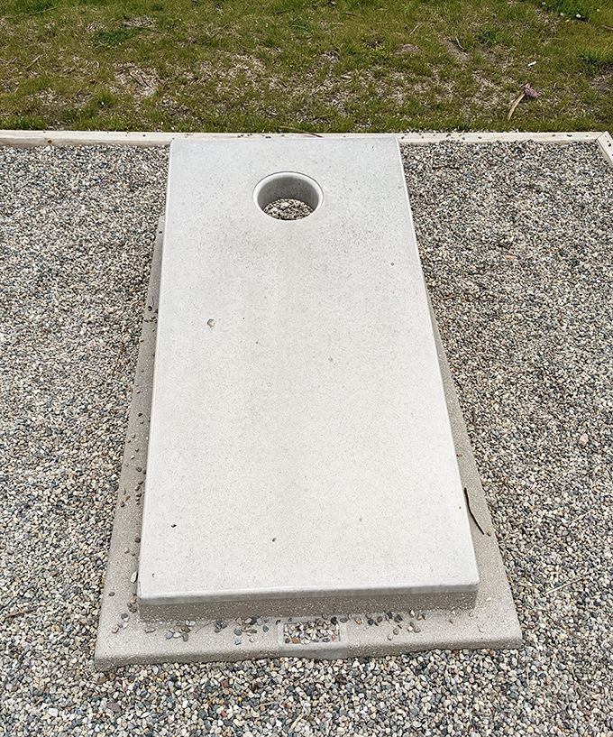 The concrete cornhole board awaits its next competitor, promising satisfying thunks and good-natured trash talk across generations.