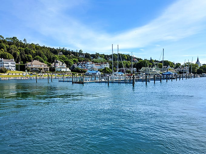 Marina docks showcase the island's nautical heart, where sailboats bob gently against the backdrop of forested hills and historic waterfront buildings.