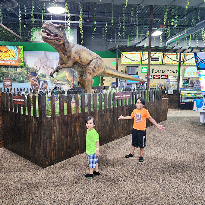 "Mom, look how small I am next to this dinosaur!" These young adventurers demonstrate the impressive scale of Fun ZoneZ's centerpiece attraction.