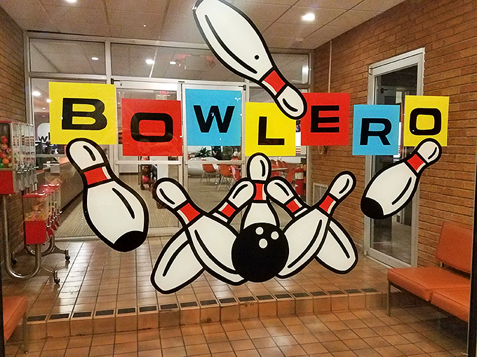 The entrance sign announces your arrival at bowling paradise with cartoon pins scattered like they've just met a perfect strike.