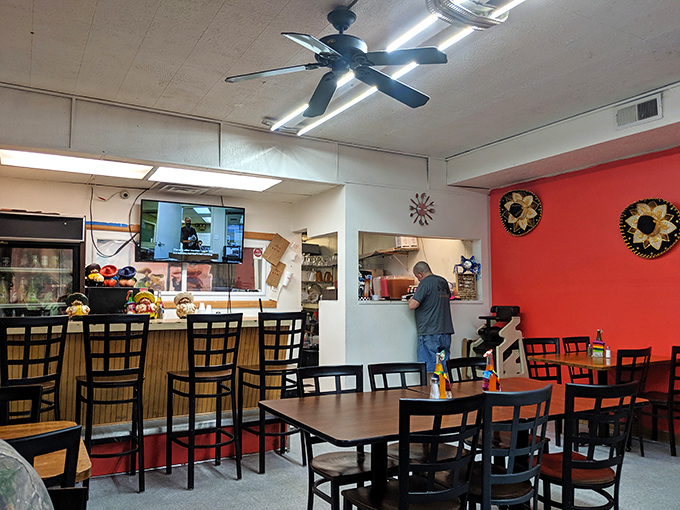 Inside, the black and white floors and colorful decor create a space that's both clean and cheerfully inviting.