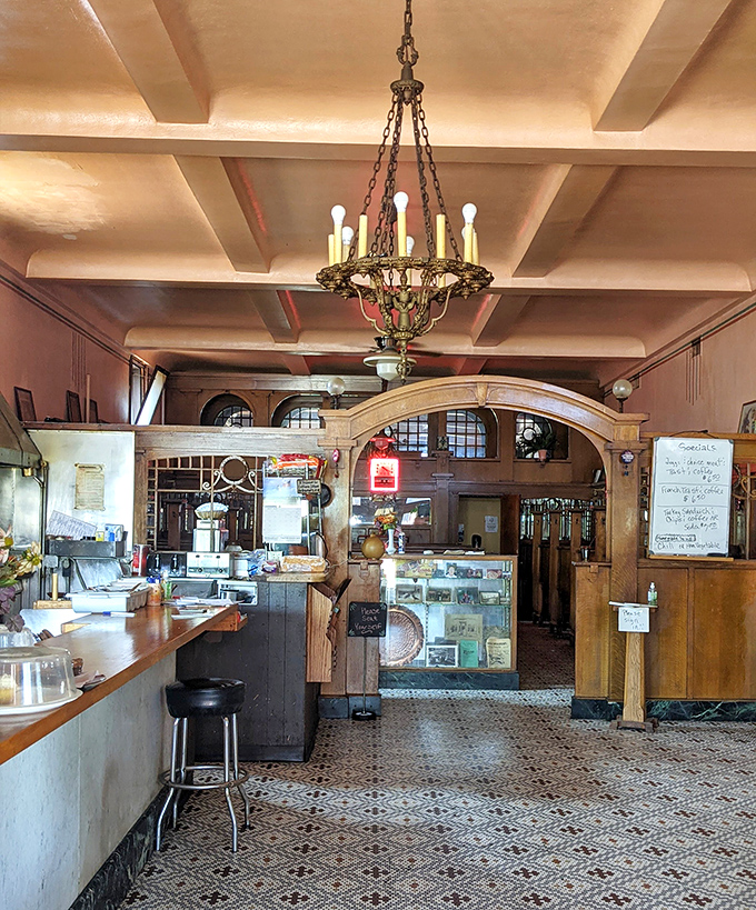 The chandelier casts a warm glow over a space where time moves more slowly and conversations aren't interrupted by notification pings.