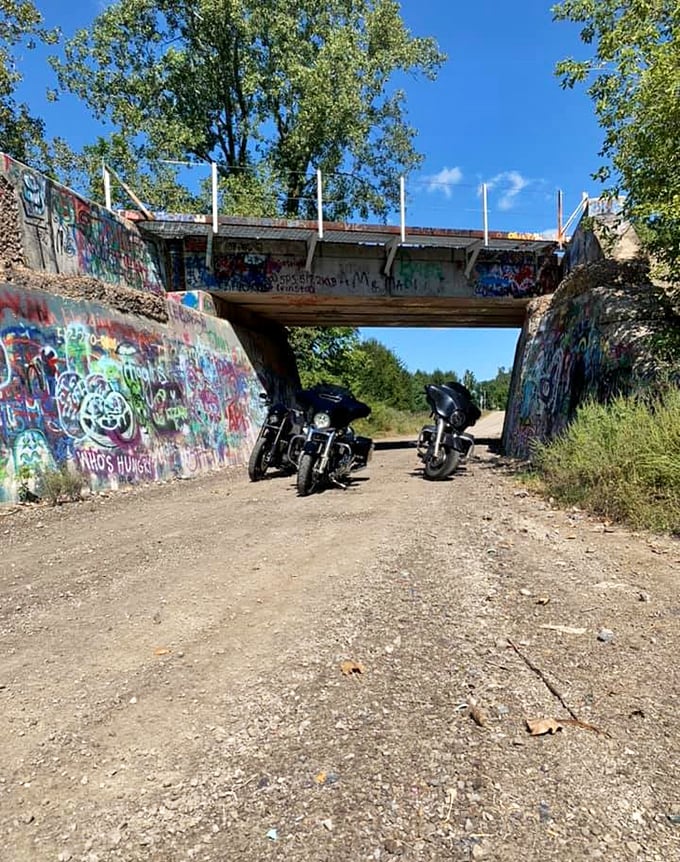 Motorcyclists often make Graffiti Bridge a destination stop during countryside rides, parking beneath the structure for memorable photos.