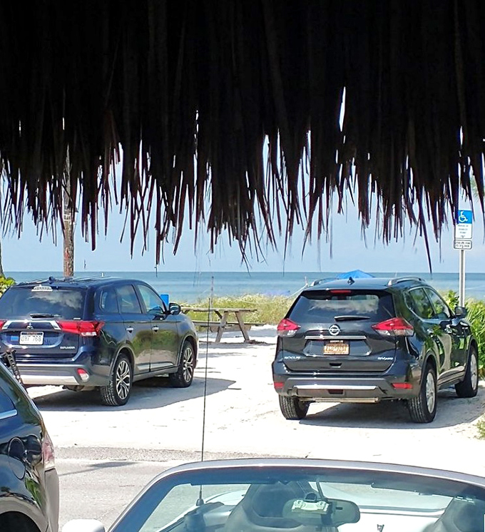 Through the thatched roof, glimpses of Gulf waters remind you that paradise is just steps away from your perfectly chilled beverage.