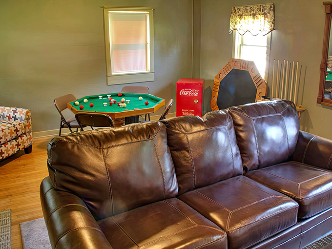The recreation room promises friendly competition around the pool table, with a vintage Coca-Cola fridge keeping beverages perfectly chilled.