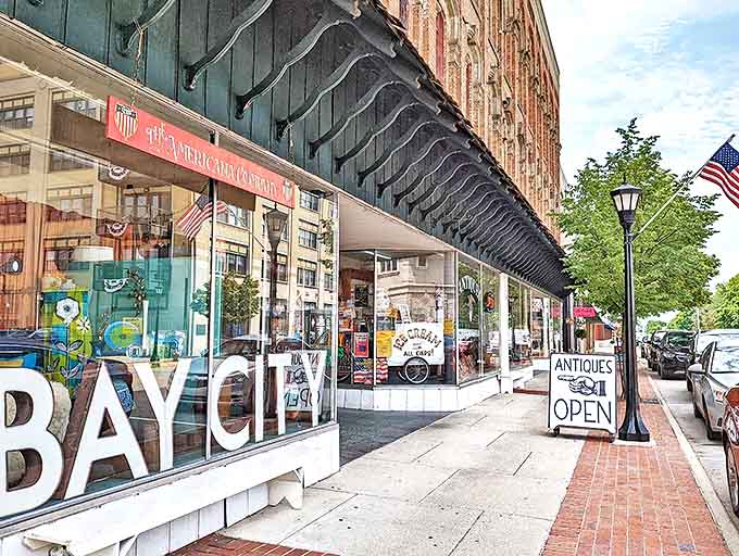Downtown storefronts invite exploration with vintage charm &ndash; where "ANTIQUES OPEN" signs promise treasure hunting adventures behind glass doors.