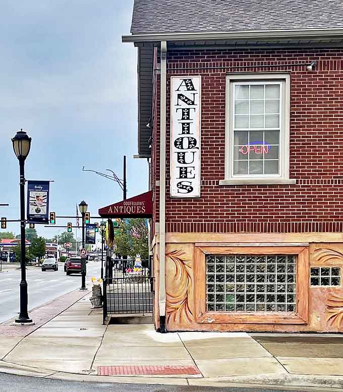 That vertical "ANTIQUES" sign has guided countless treasure hunters to this brick building filled with memories waiting to be adopted.