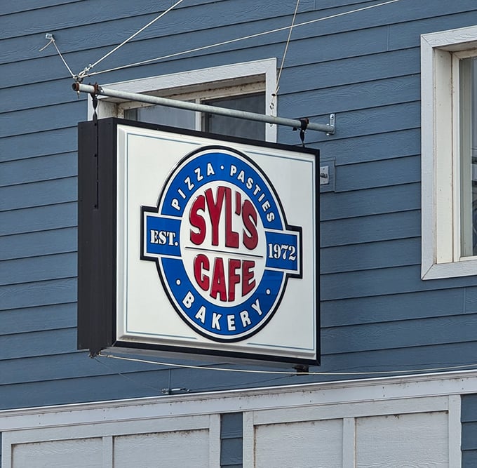 The iconic Syl's Cafe sign promises pizza, pasties, and bakery delights &ndash; a beacon of deliciousness in Michigan's Upper Peninsula since 1972.