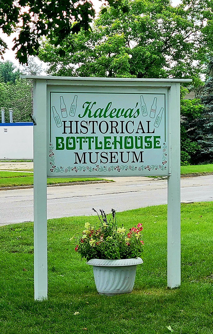 The museum's cheerful sign invites visitors to discover this unique attraction, with bottle illustrations hinting at the architectural wonder that awaits.