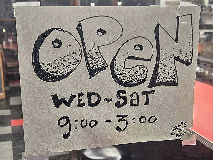 The hand-drawn "OPEN" sign tells you everything you need to know – Wednesday through Saturday, 9 to 3, when food magic happens.