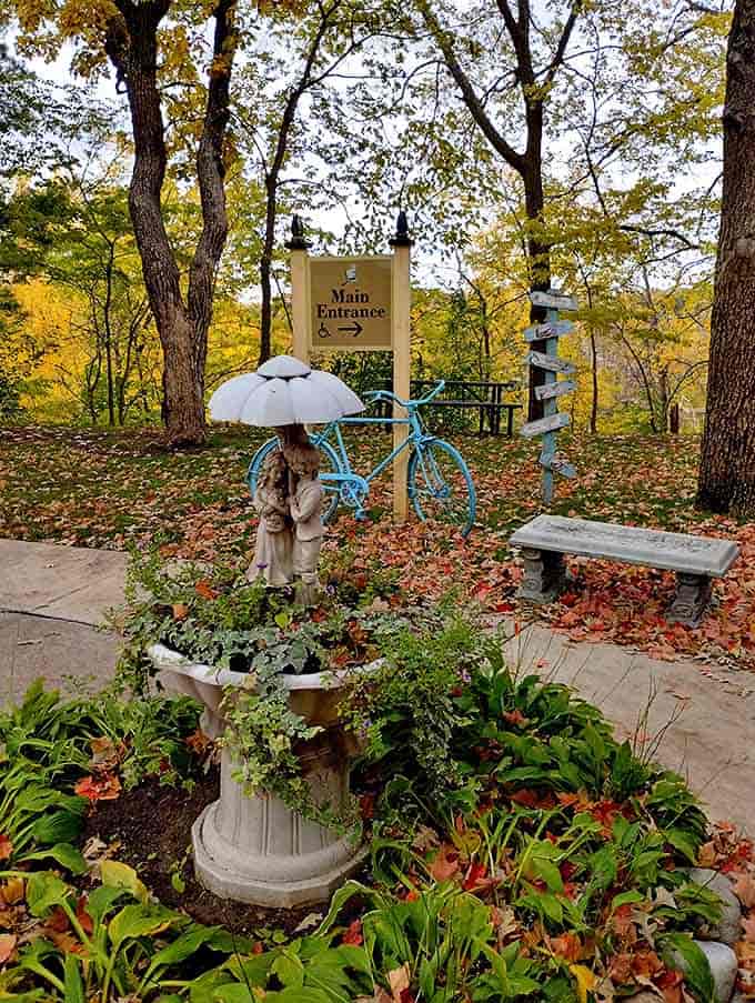 Whimsical garden pathways guide visitors to the main entrance, where even the blue bicycle seems to have arrived from a storybook.