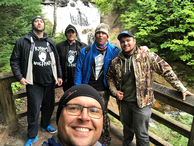 Friends create memories against nature's perfect backdrop, where conversations flow as freely as the water behind them.