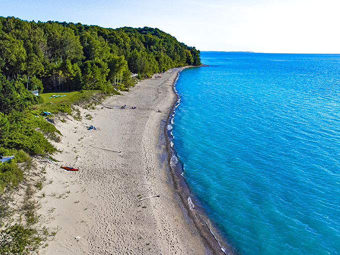 From above, Christmas Cove reveals its protected curve and that stunning water color that makes people ask "wait, this is Michigan?"